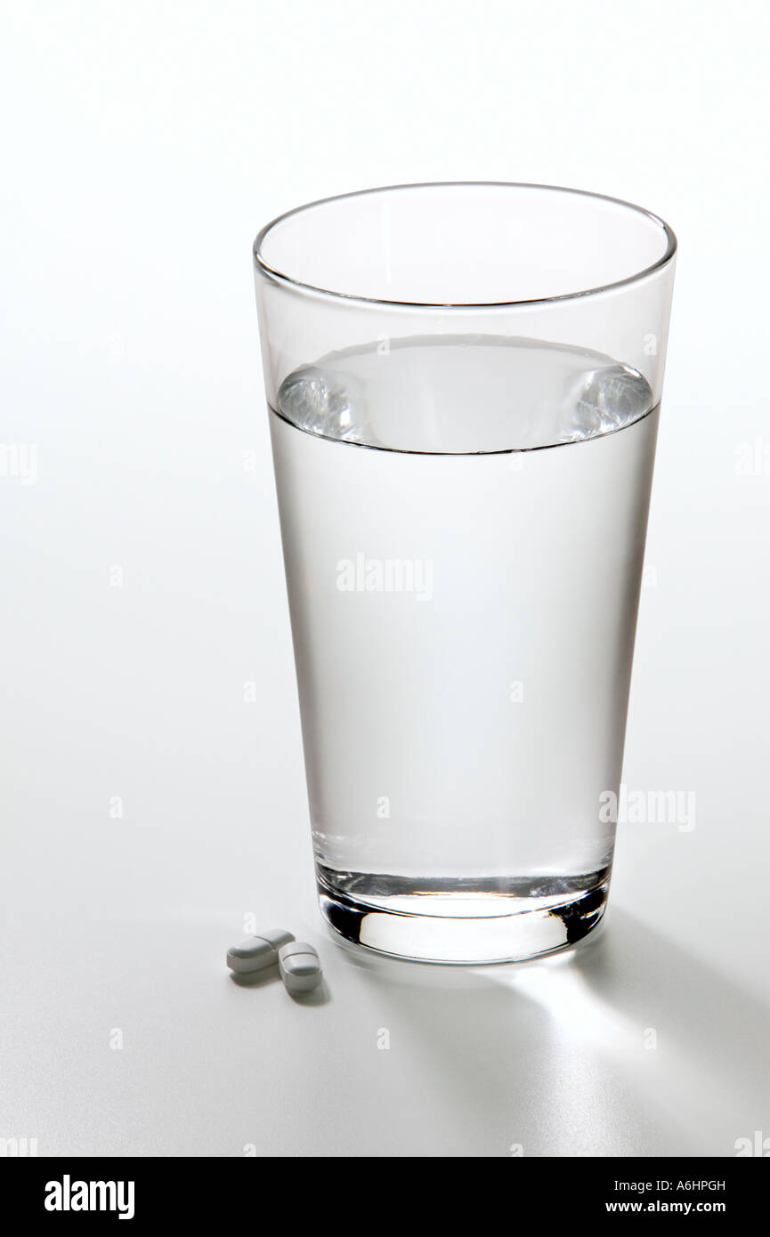 Water glass on white w pills Stock Photo - Alamy