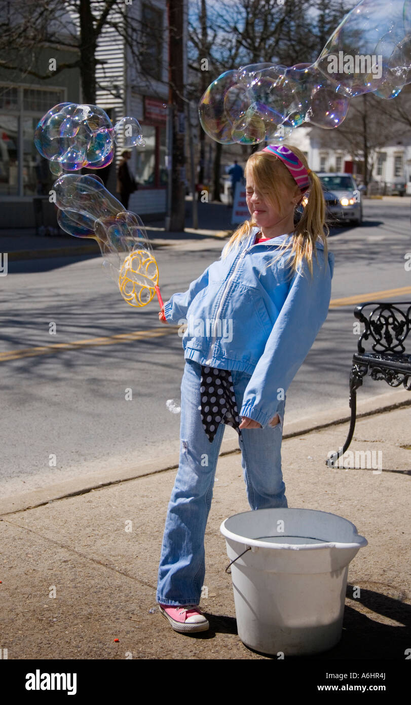 Child waving a wand as she makes bubbles Stock Photo - Alamy