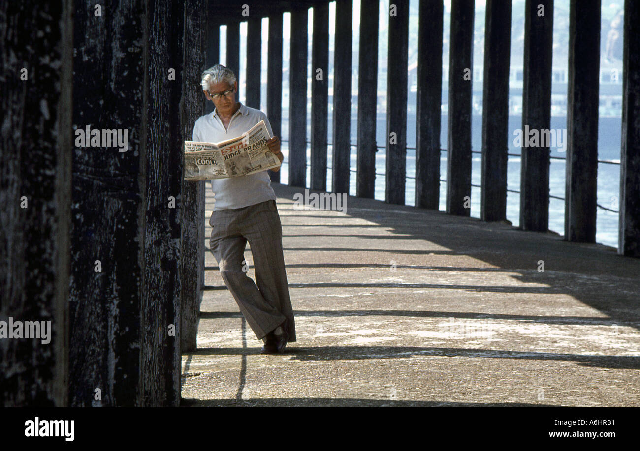 Man reading tabloid paper hi-res stock photography and images - Alamy