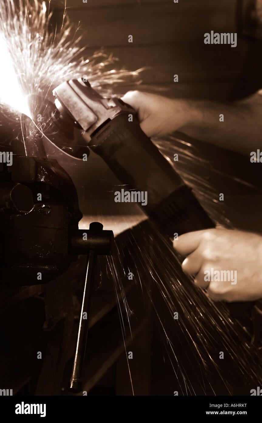 Close up of a mans hands with grinder creating sparks Stock Photo - Alamy