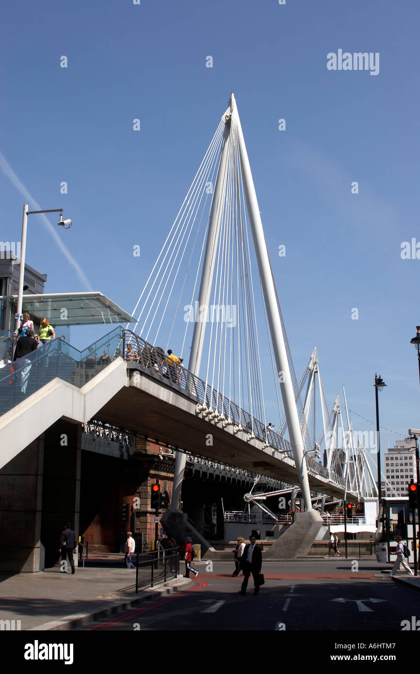 Hungerford footbridge over River Thames from south west with people in ...