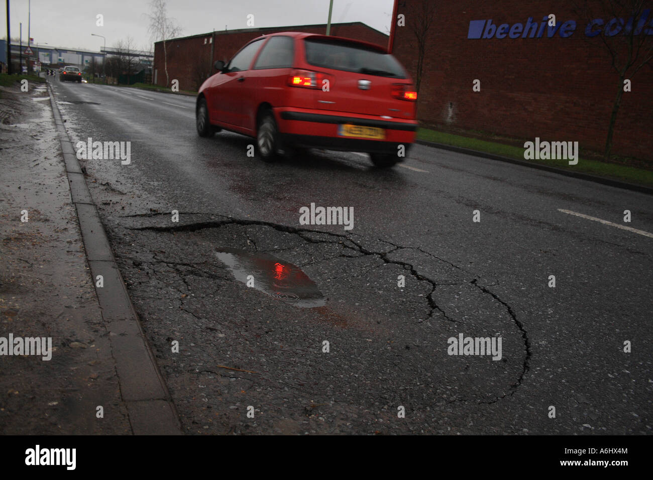 Pothole in road with car avioding Stock Photo - Alamy