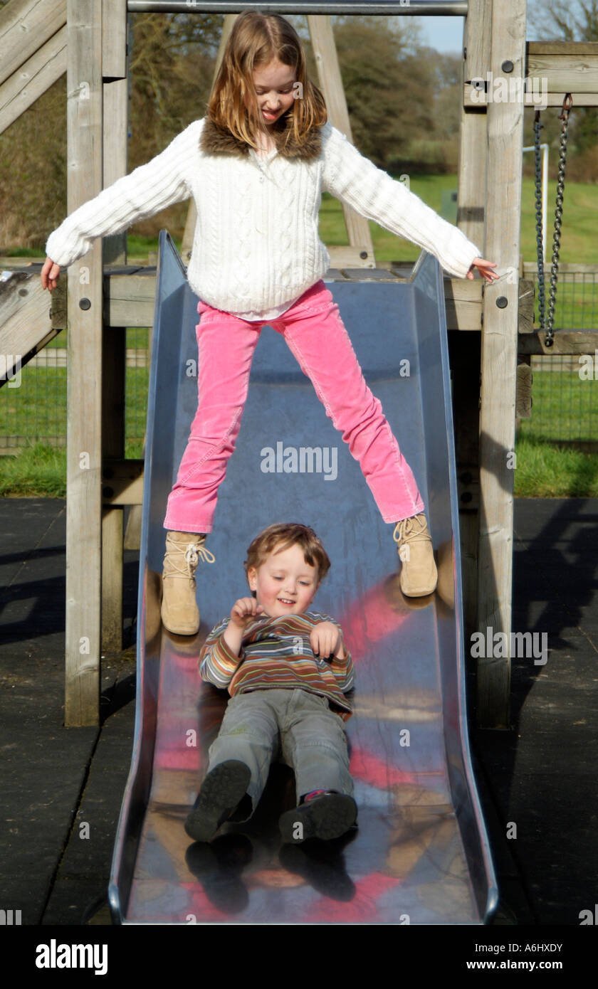Children playing on a slide Childrens playground Brother and sister ...