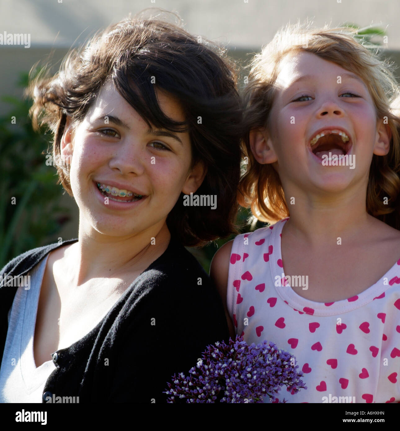 Girls sisters young children enjoying a laugh Stock Photo - Alamy