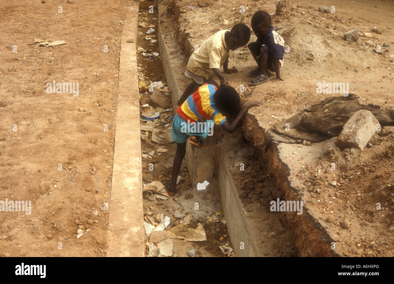 Kids play in gutter Gambia Stock Photo - Alamy