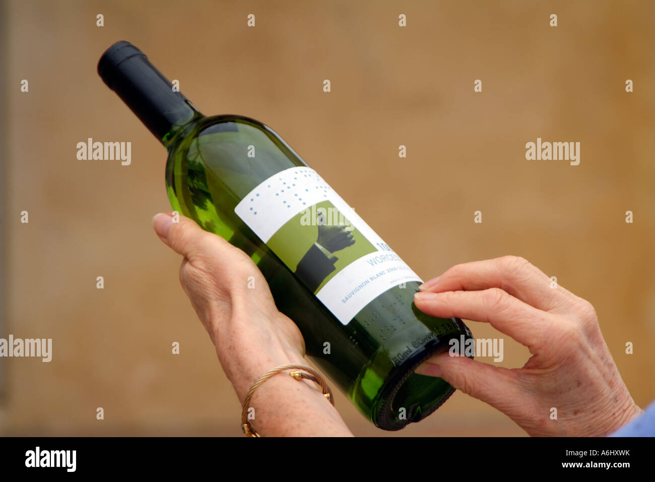 Reading Braille Raised writing on a wine bottle and label for use by ...