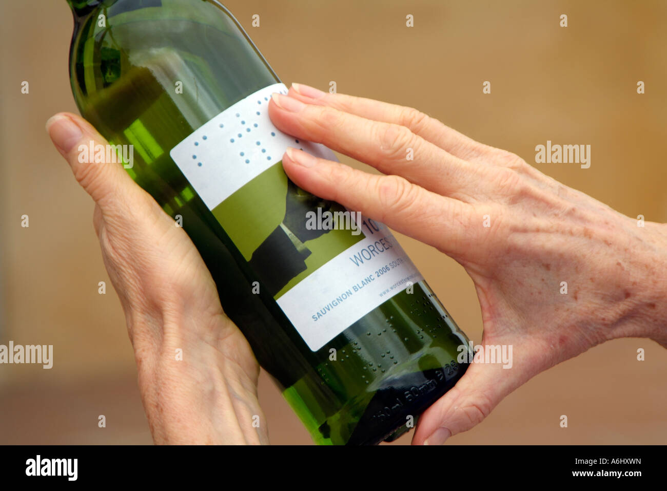 Reading Braille Raised writing on a wine bottle and label for use by ...
