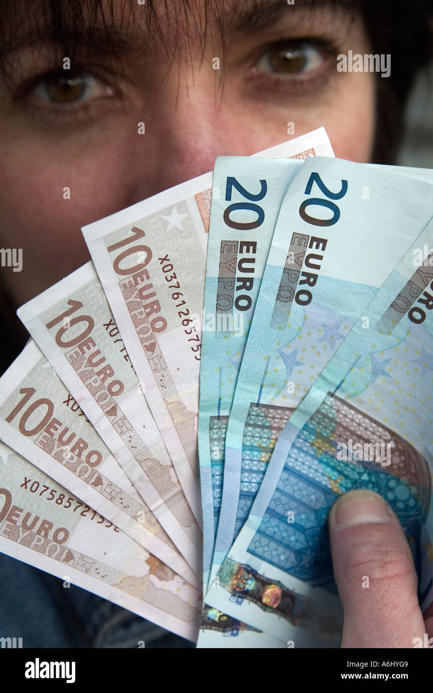 Euro banknote in hand Stock Photo - Alamy