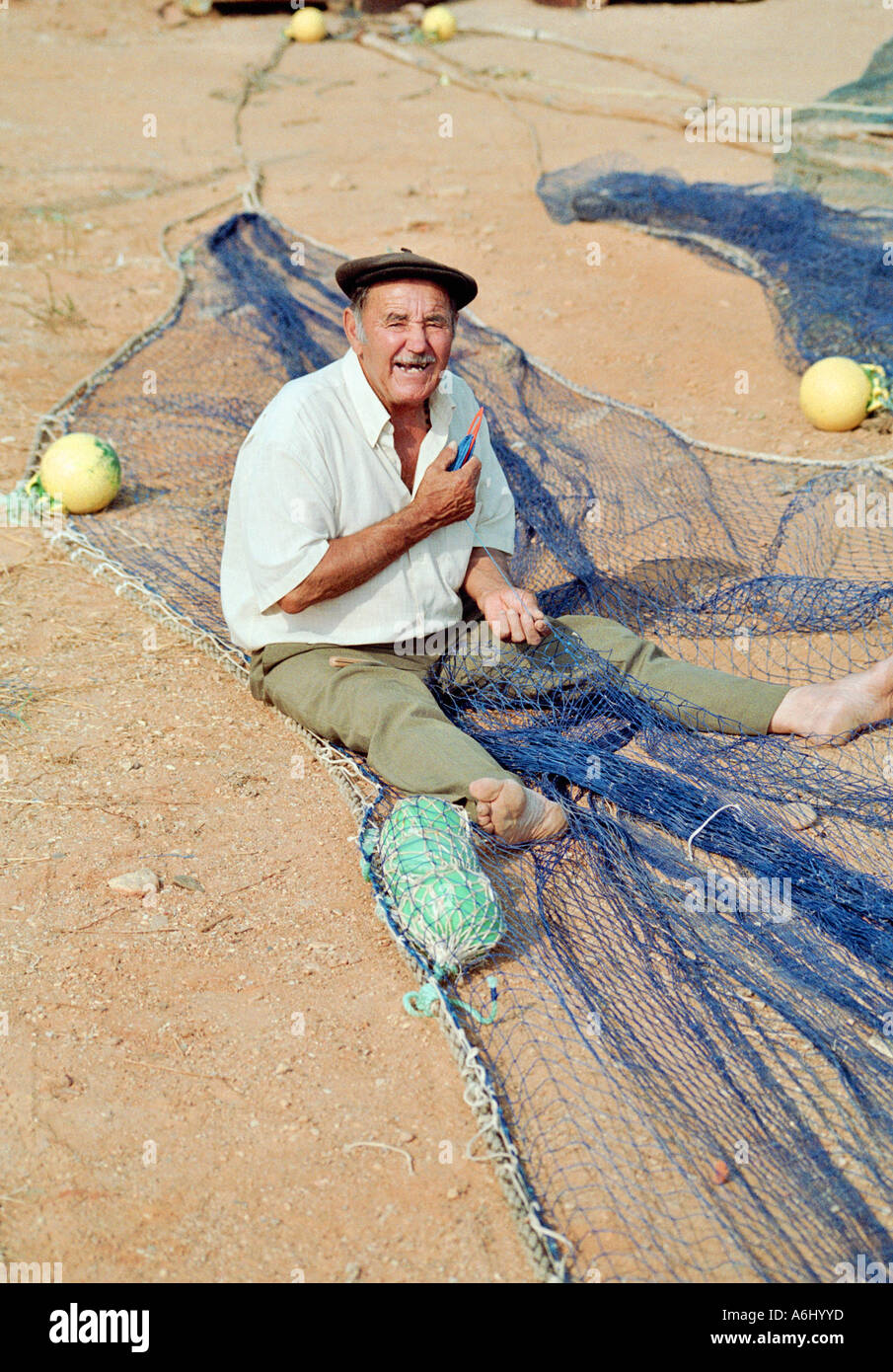 Spanish fisherman mending nets Stock Photo - Alamy