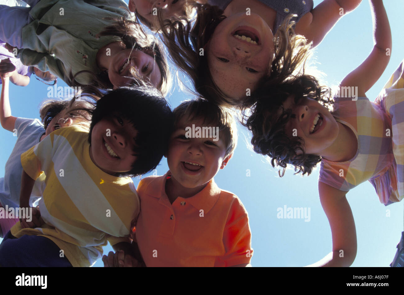 Laughing Group of Children Looking Down Stock Photo - Alamy