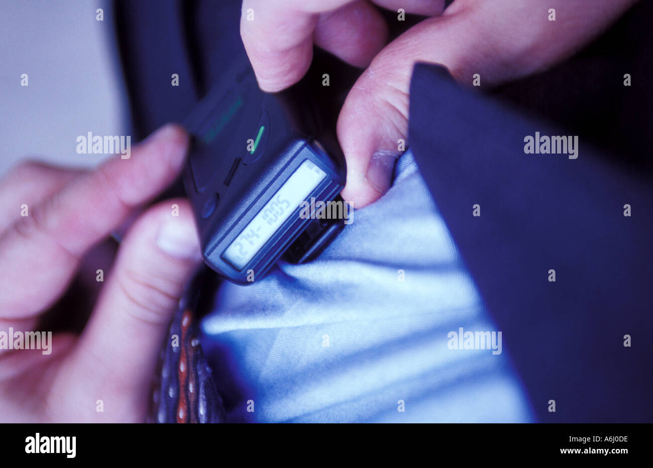 Man Checking his Pager Stock Photo - Alamy