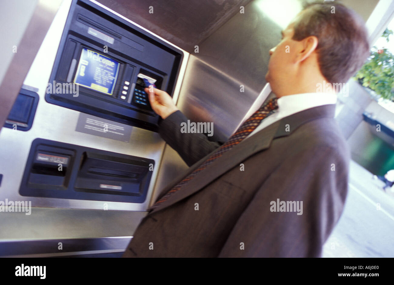 Man Using an ATM Stock Photo - Alamy