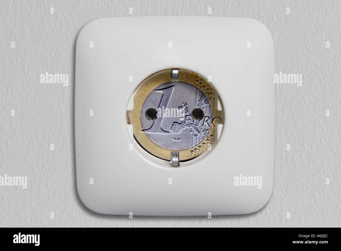 Wall socket and euro coin Stock Photo - Alamy