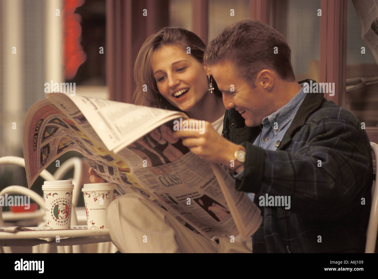 Couple Reading the Newspaper Together Stock Photo - Alamy
