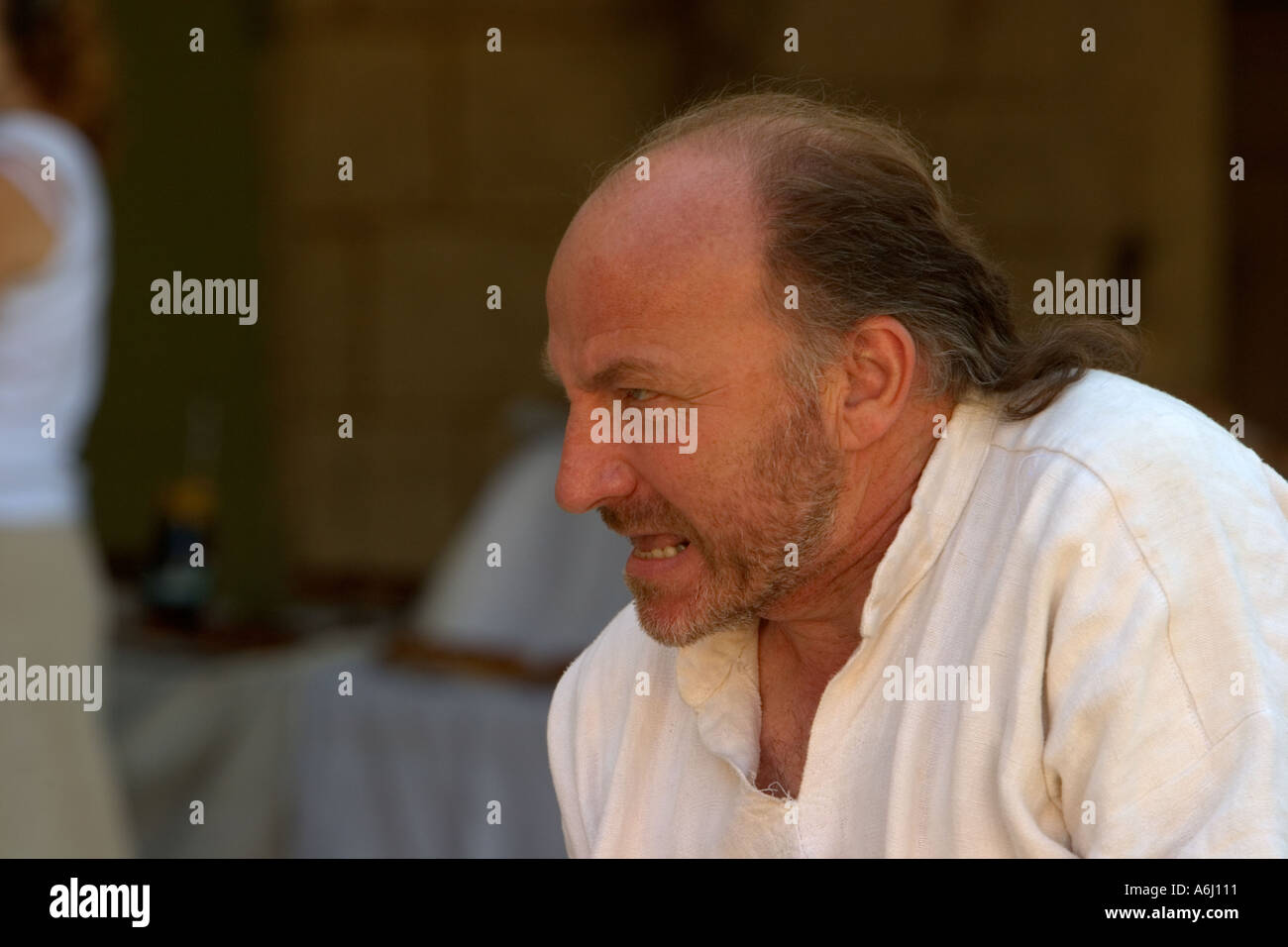 Man in close up wearing french period costume grimacing in french ...