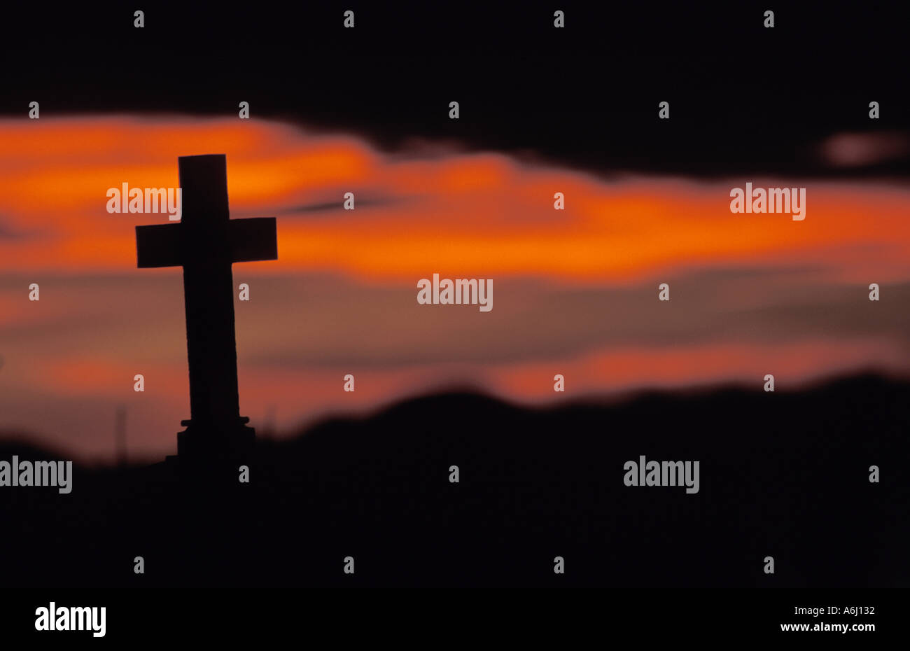 Sun Setting on Lone Cross in Graveyard Stock Photo - Alamy