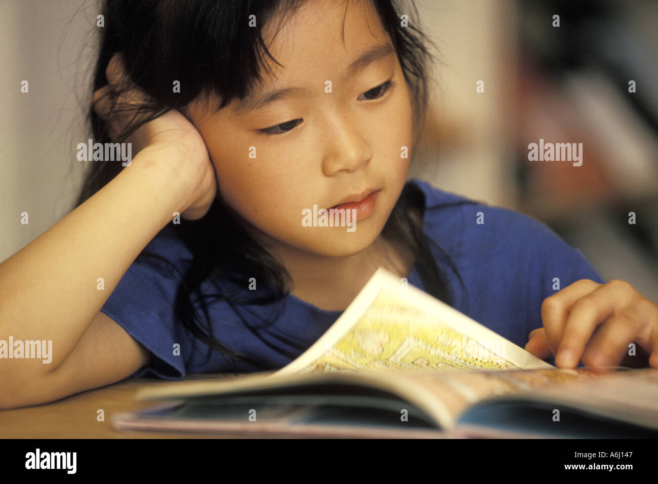 Little Girl Reading a Book Stock Photo - Alamy