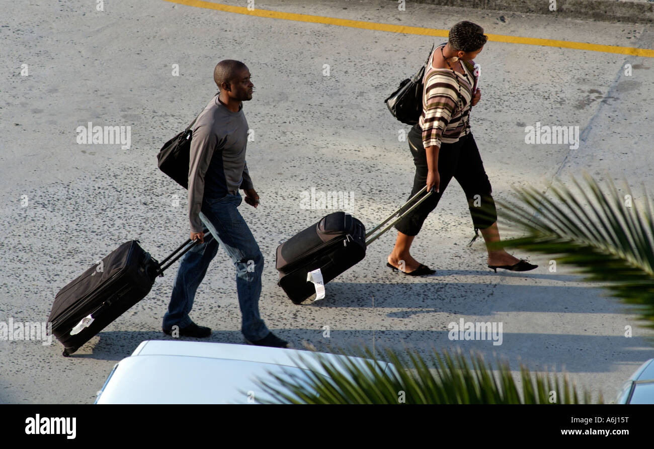 Luggage on wheels People pull suitcase Stock Photo - Alamy