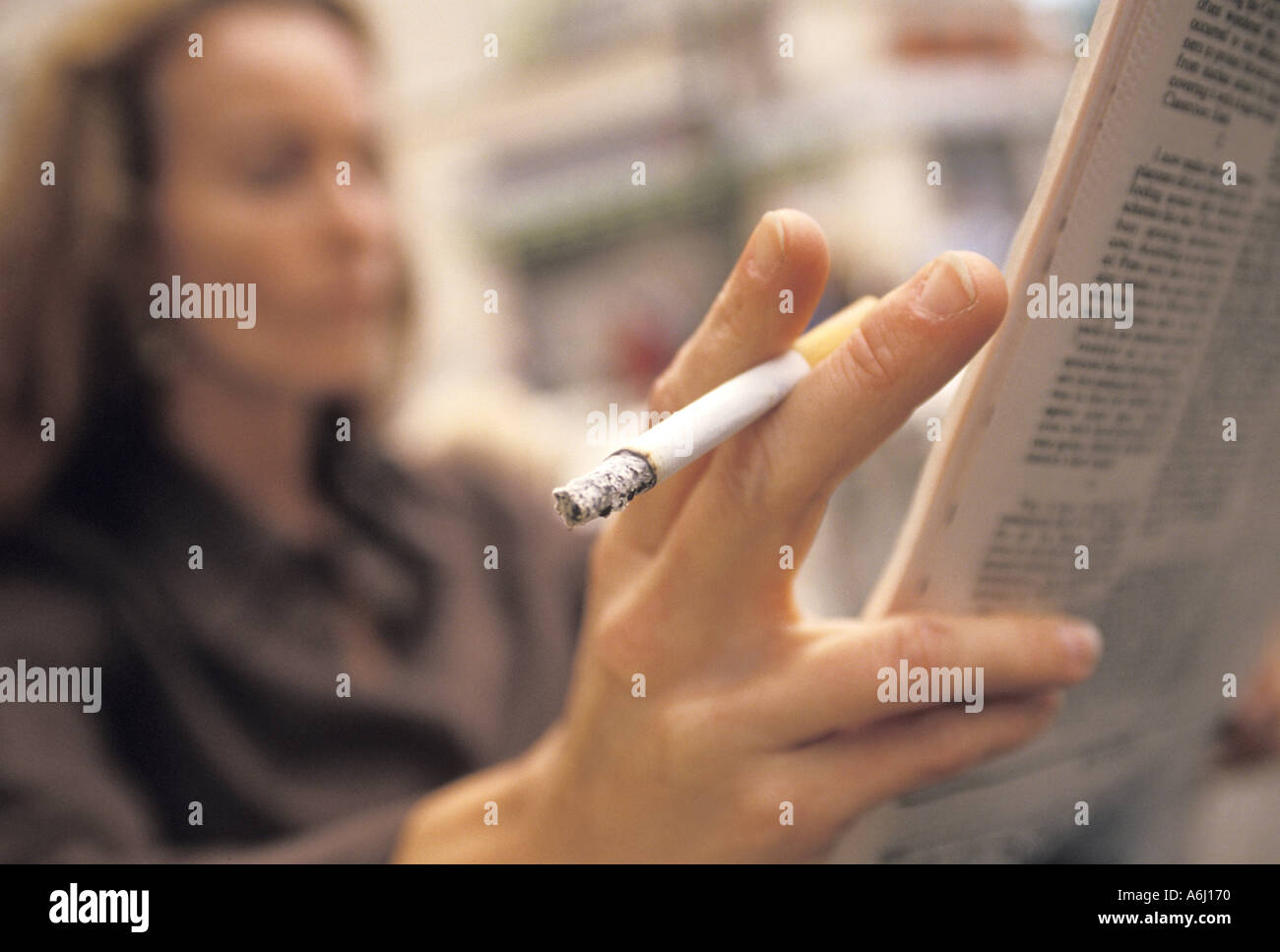 Woman Smoking and Reading the Paper Stock Photo - Alamy