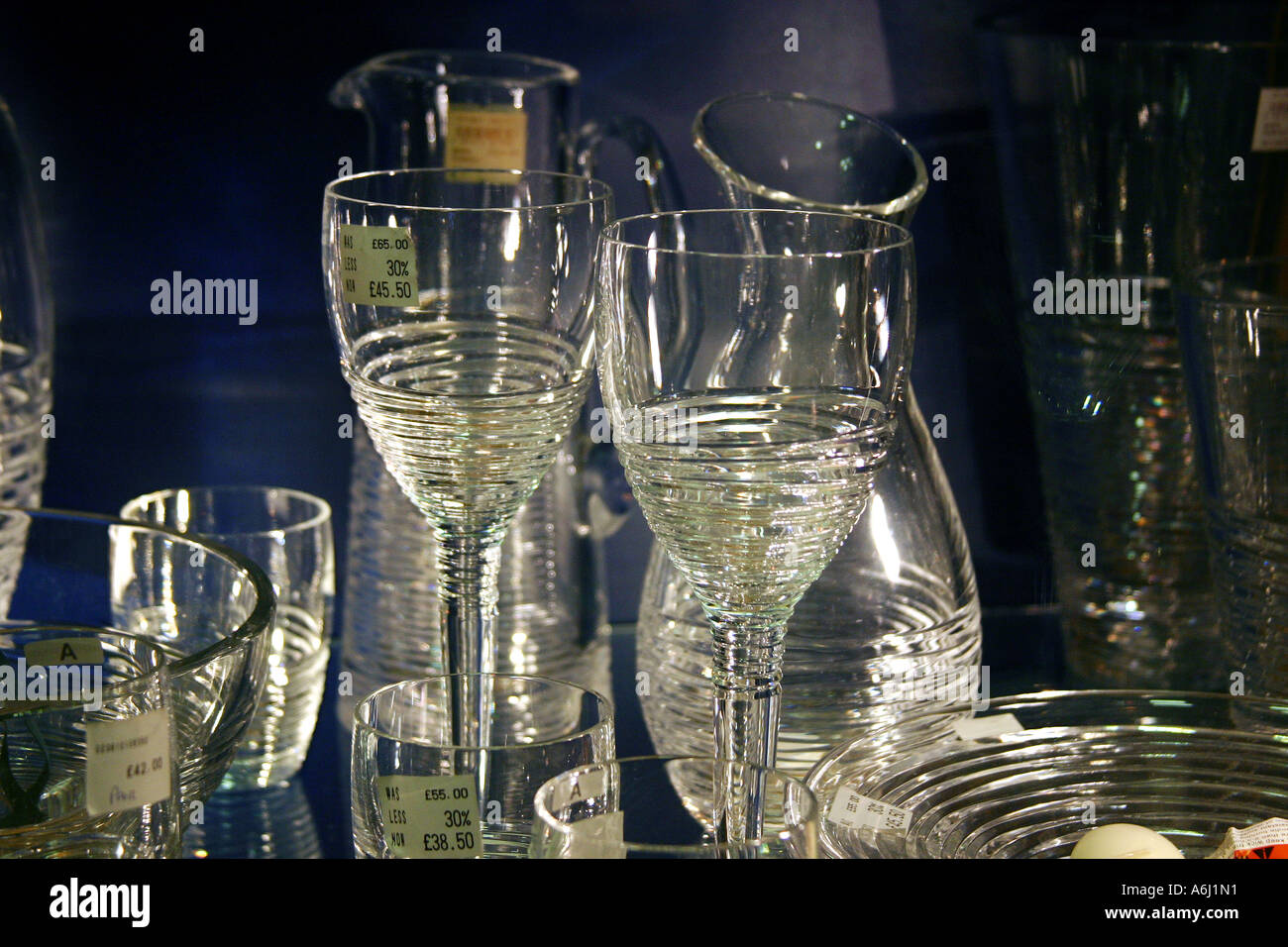 Glass objects on display in a shop for sale with price tags Stock Photo ...