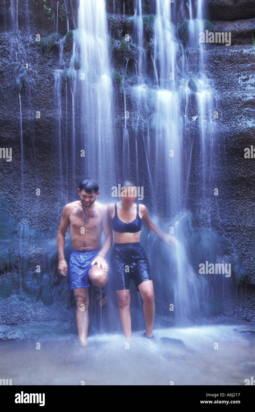 Man and Woman Standing Under a Waterfall Stock Photo - Alamy