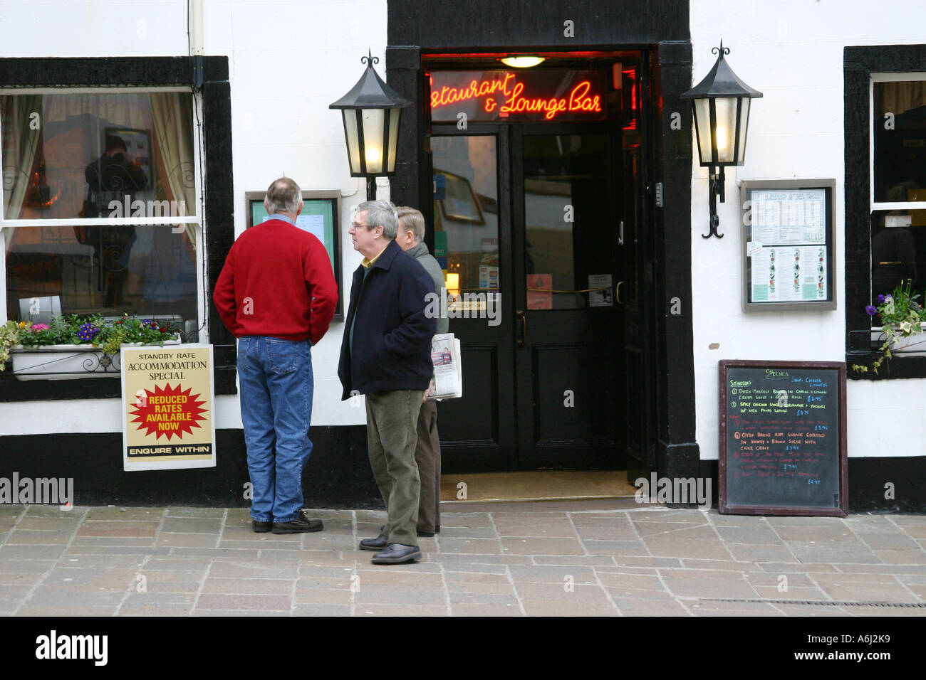 Group of people looking at menu outside restaurant which also offers ...