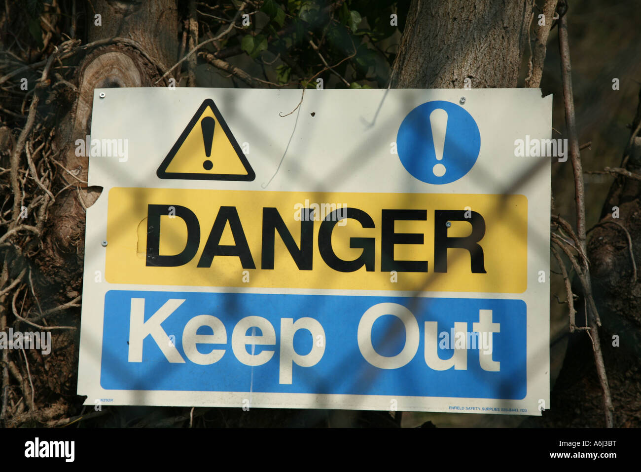 danger keep out warning sign behind a fence Stock Photo - Alamy