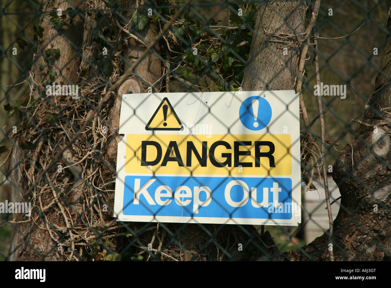 danger keep out warning sign behind a fence Stock Photo - Alamy