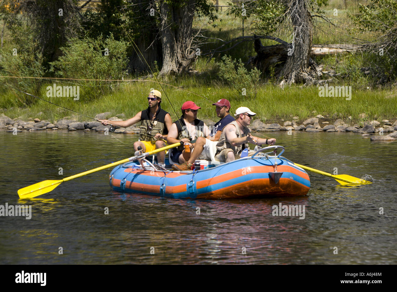 WISE RIVER MONTANA USA Young men fly fishing from raft on the Big Hole ...