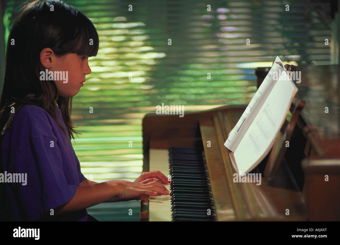 profile of a young girl practicing piano Stock Photo - Alamy