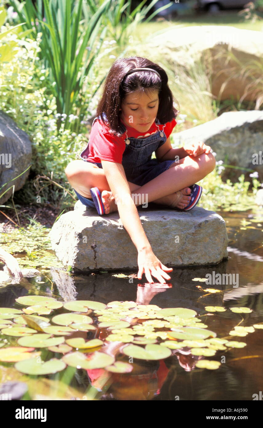 Little Girl Playing in Pond Stock Photo - Alamy