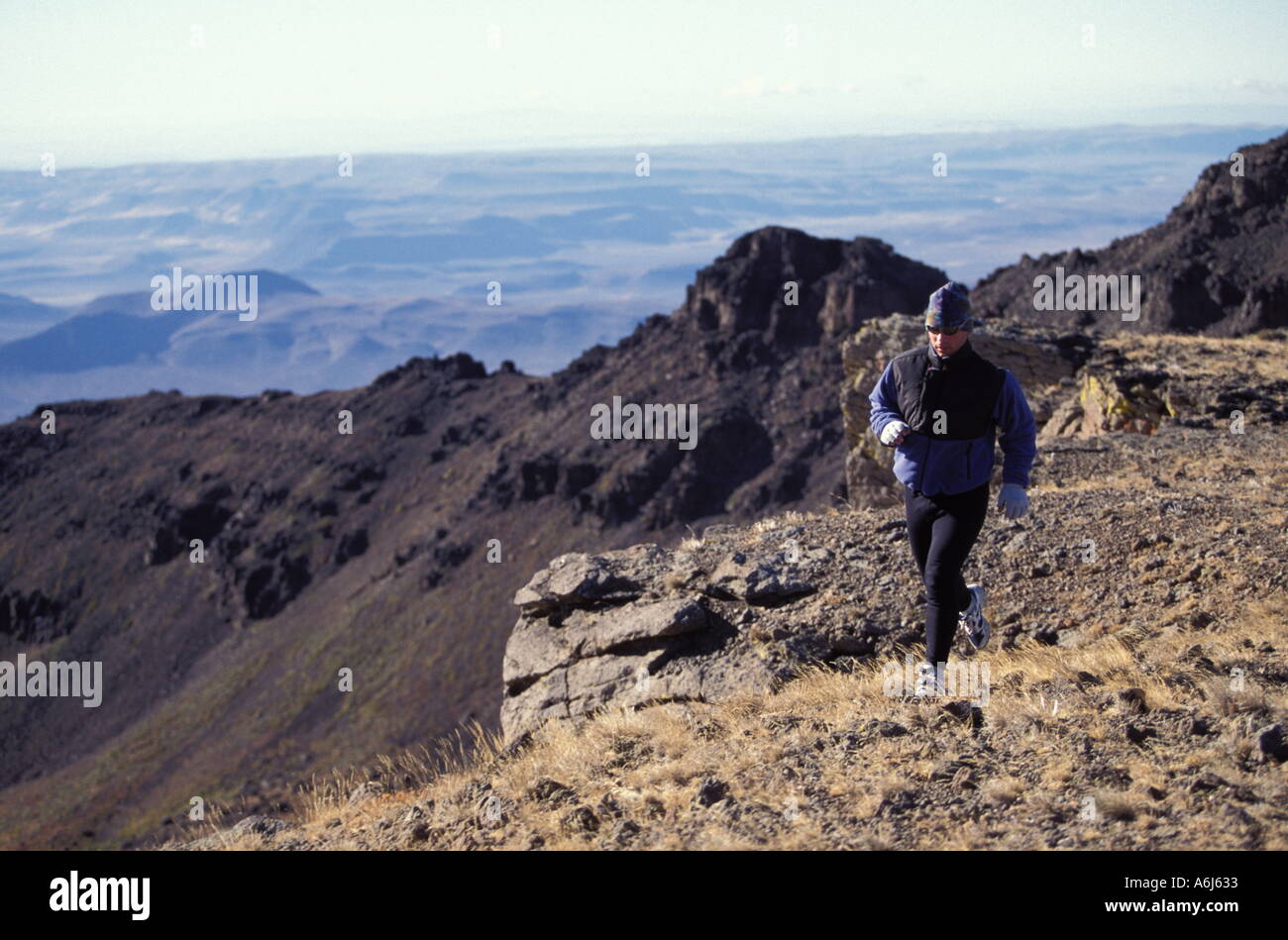 Man Running on High Ridge Stock Photo - Alamy