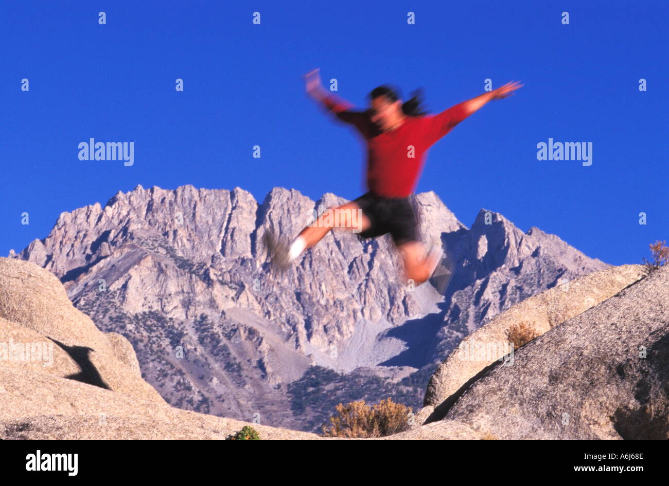 Man Jumping Over Rocks Stock Photo - Alamy