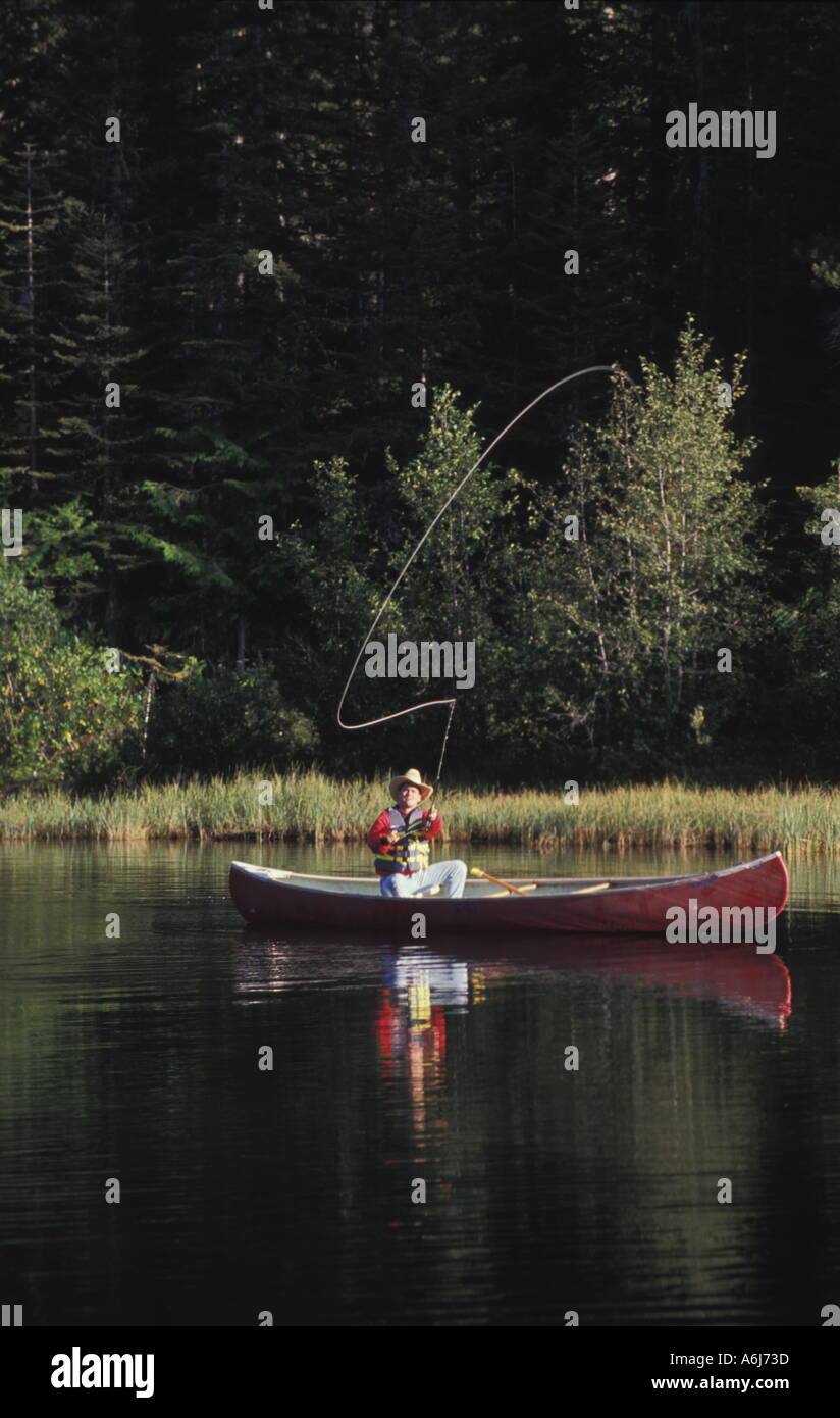 Man Fishing in Canoe Stock Photo - Alamy