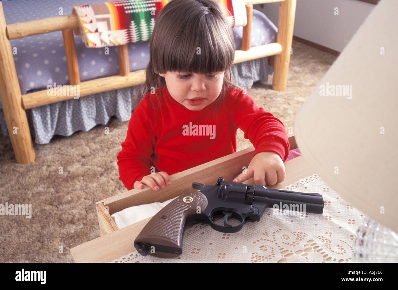 Little Girl Finding a Gun Stock Photo - Alamy
