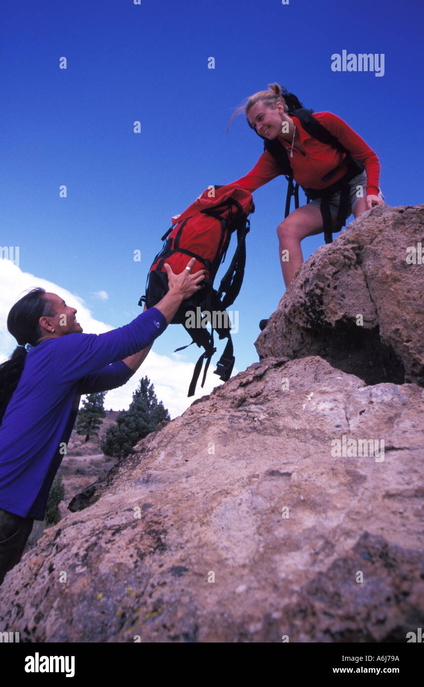 Man Handing Woman a Backpack Stock Photo - Alamy