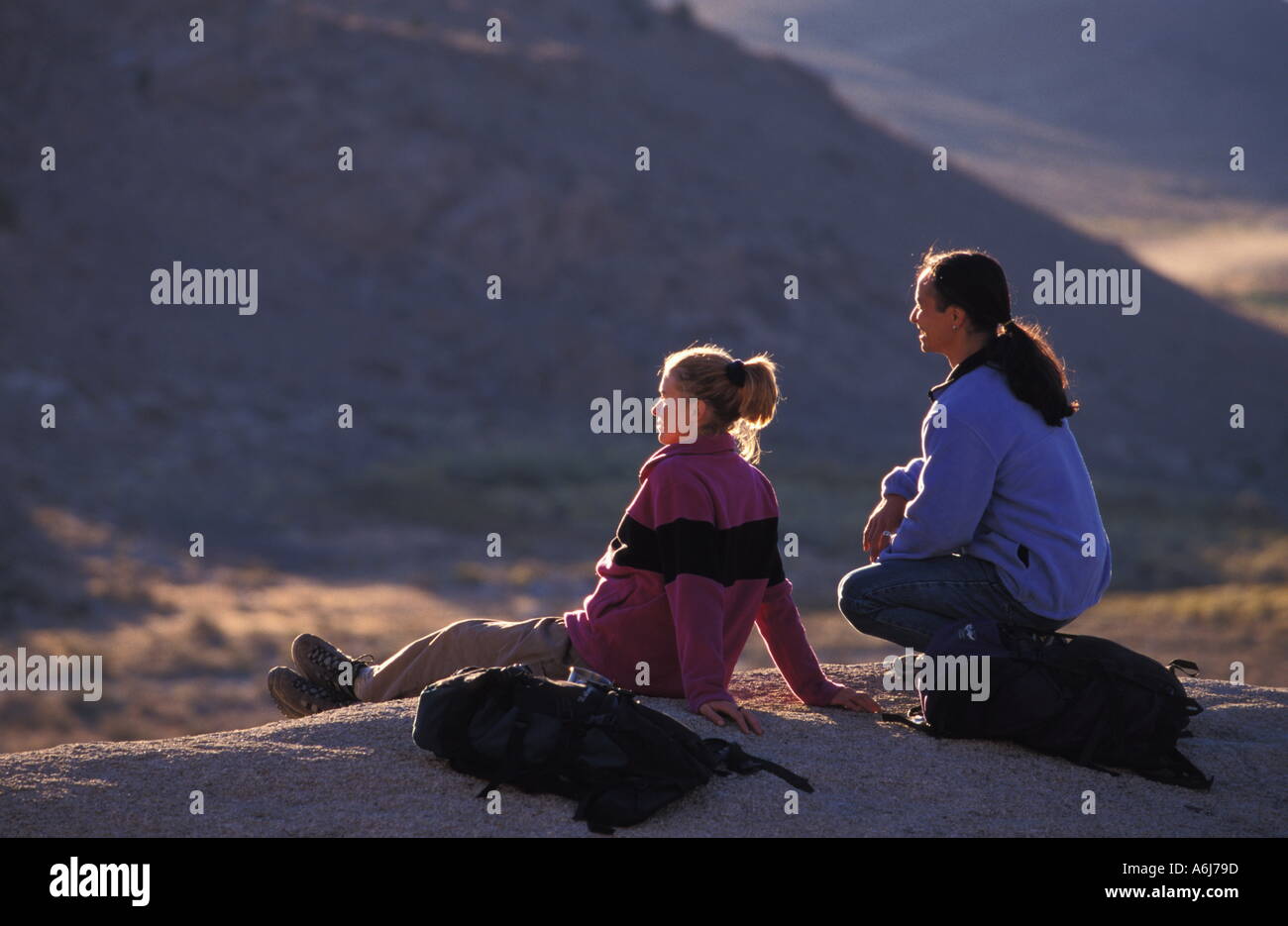 Man and Woman Sitting on Rock Together Stock Photo - Alamy