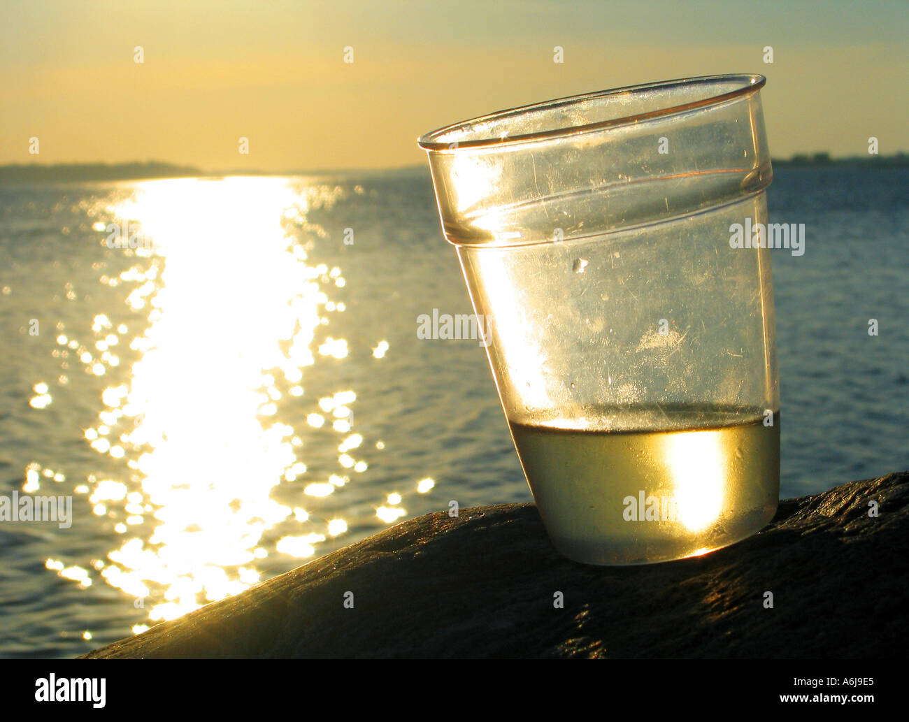 Glass of wine in the sunset by the ocean in the archipelago of ...