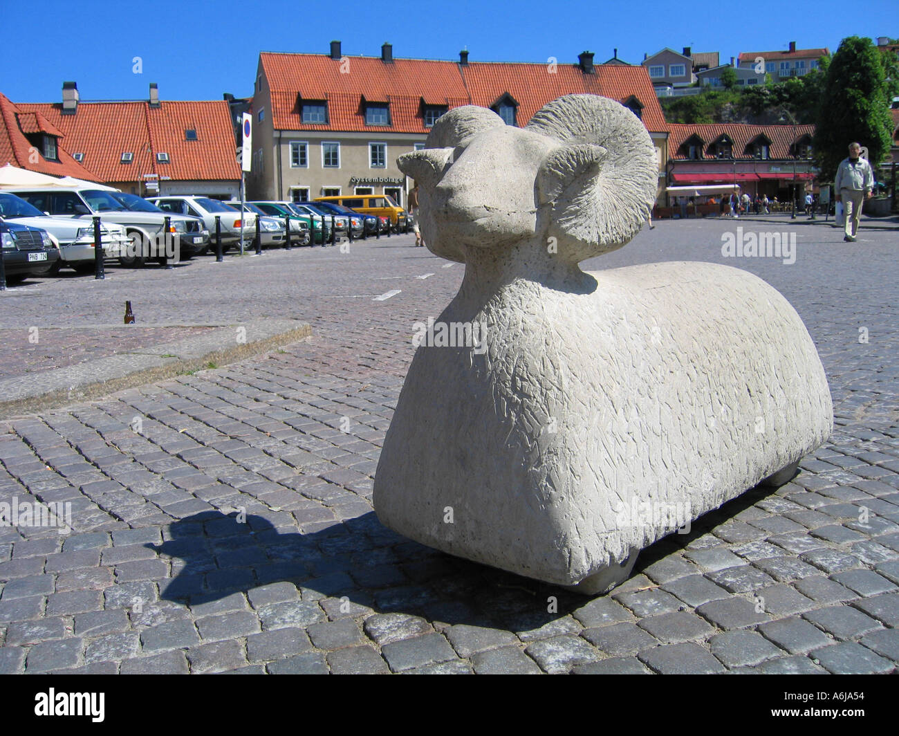 A sculpture of a sheep guarding the main square of the medieval town of ...