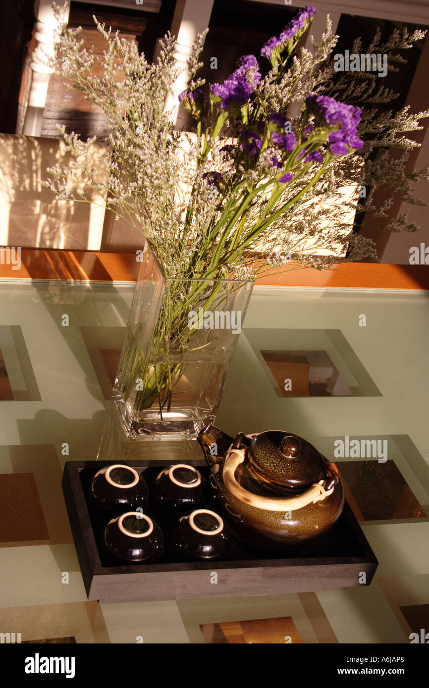 Chinese tea set on a kitchen table with flowers Stock Photo - Alamy