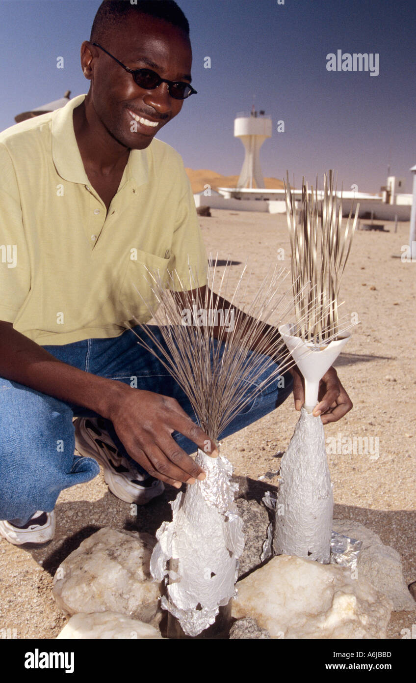 African scientist technician demonstrating designs of devices to ...