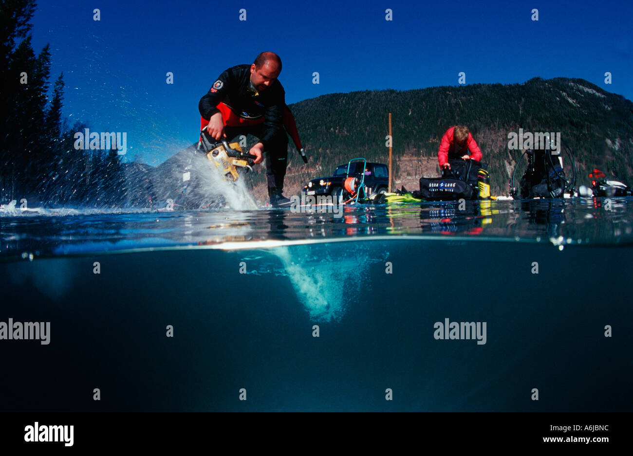 ice diver cutting out a hole in the ice Stock Photo - Alamy