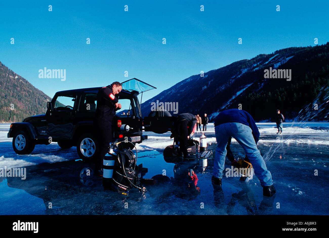 ice diver cutting out a hole in the ice Stock Photo - Alamy