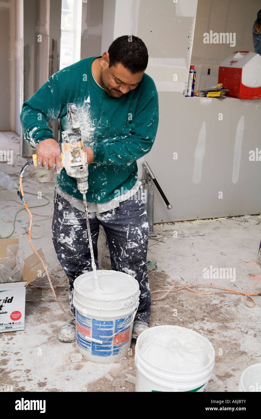 Immigrant Worker mixing Drywall Joint Compound Building 1 Stock Photo ...