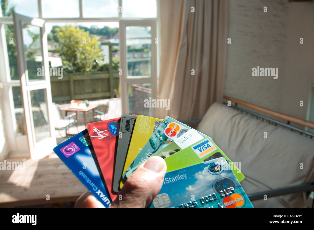 Homeowner holding a fan of Credit Cards Stock Photo - Alamy