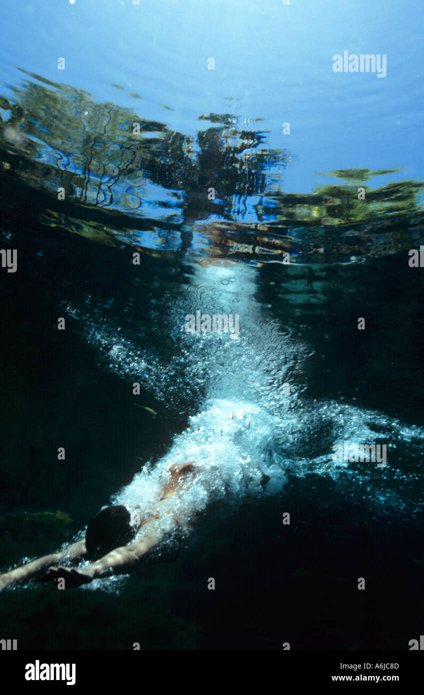 Woman diving into water bubbles Stock Photo - Alamy