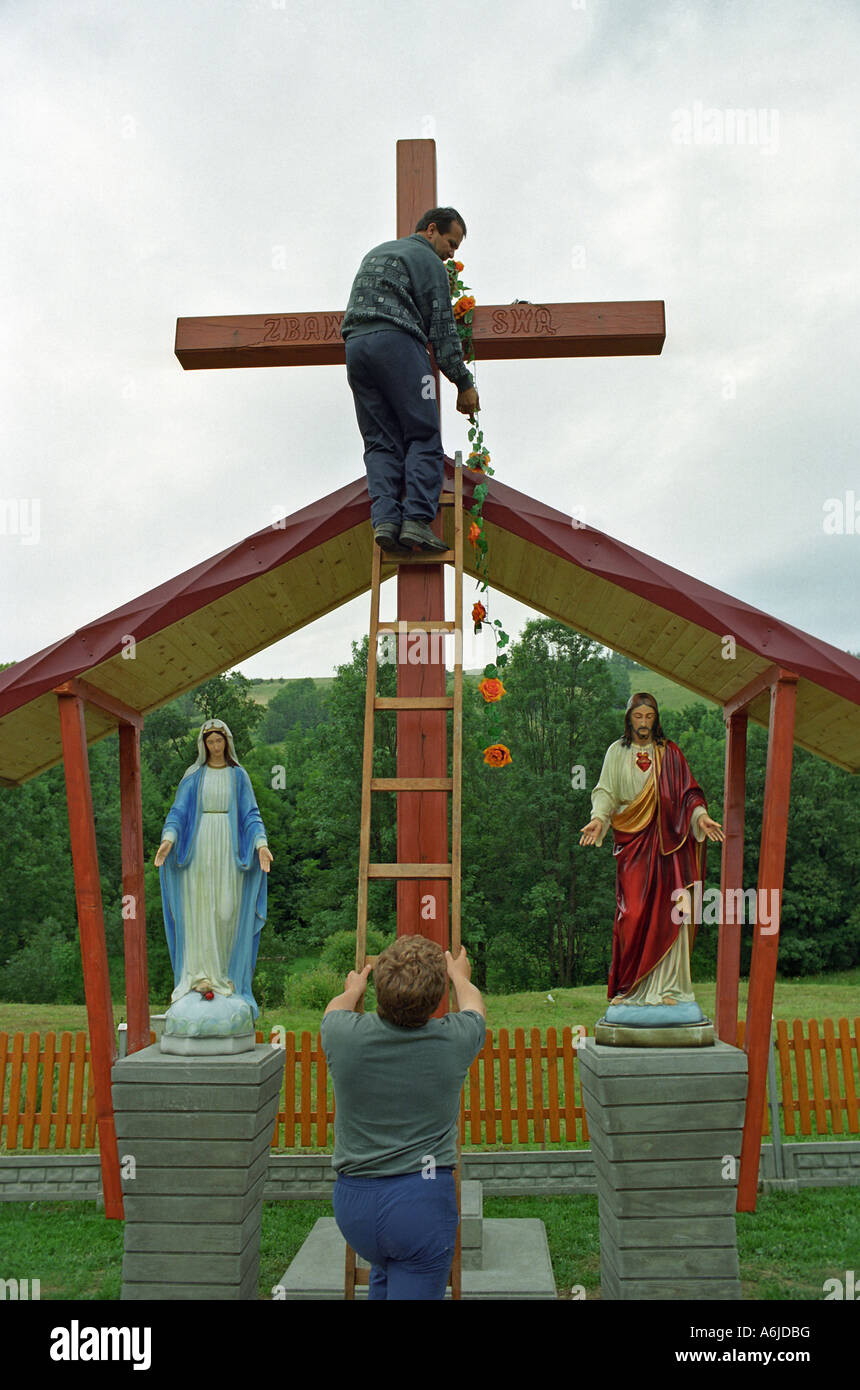 Men decorating the cross for a consecration ceremony, Turzansk, Poland ...