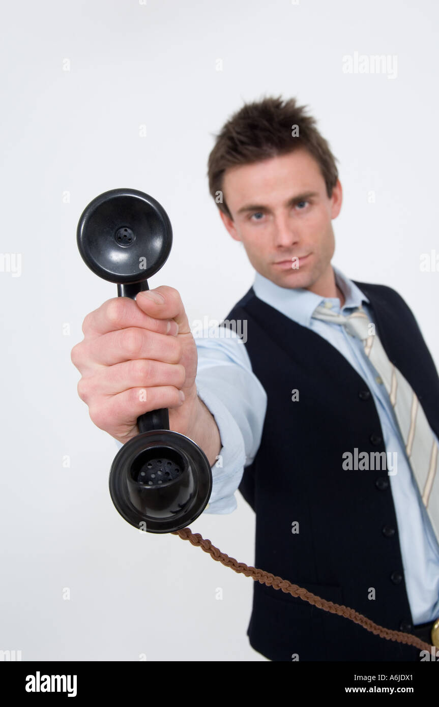 man passing the telephone it s for you phone call Stock Photo - Alamy