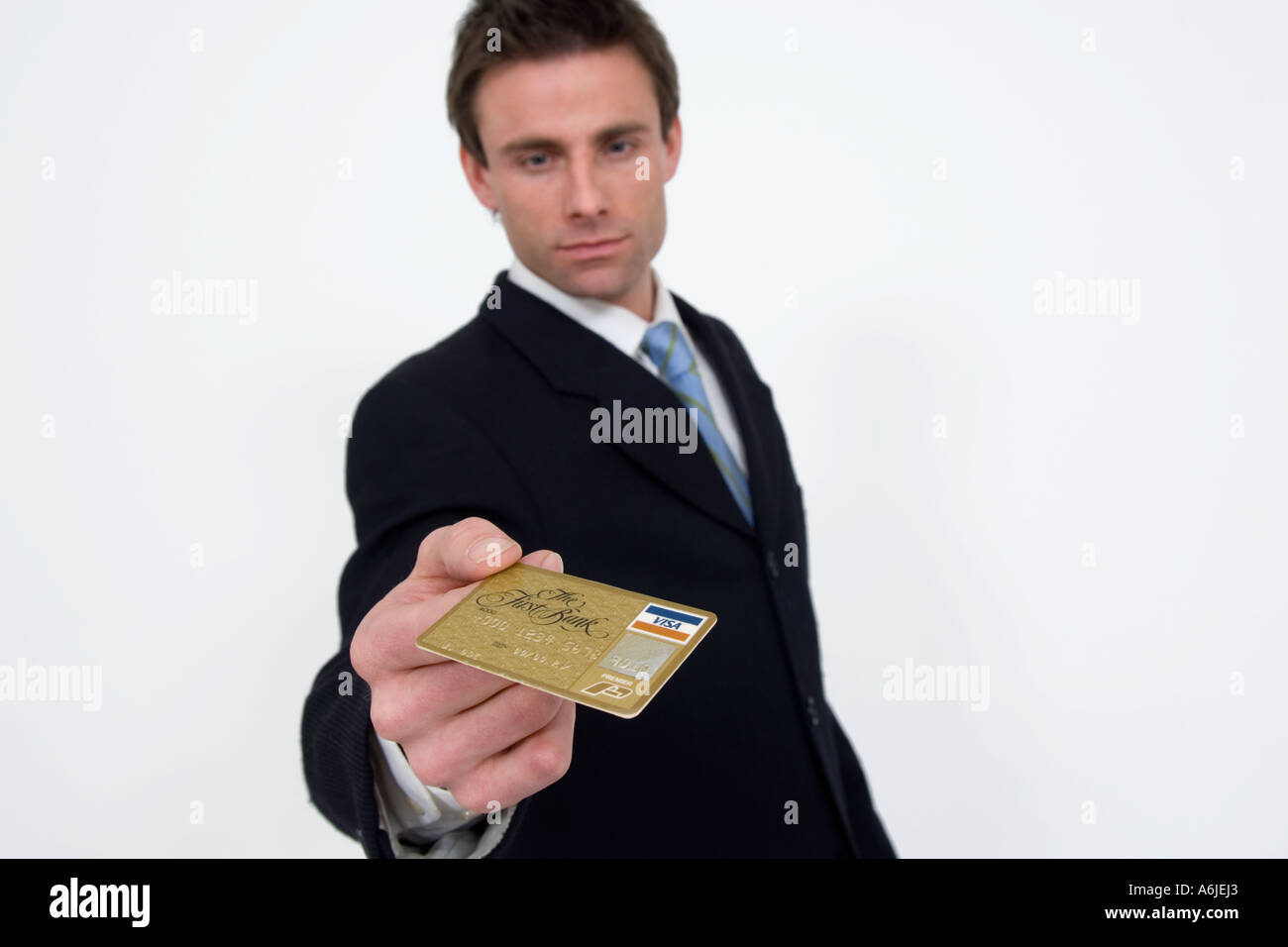 businessman handing over a gold credit card credit crunch Stock Photo ...