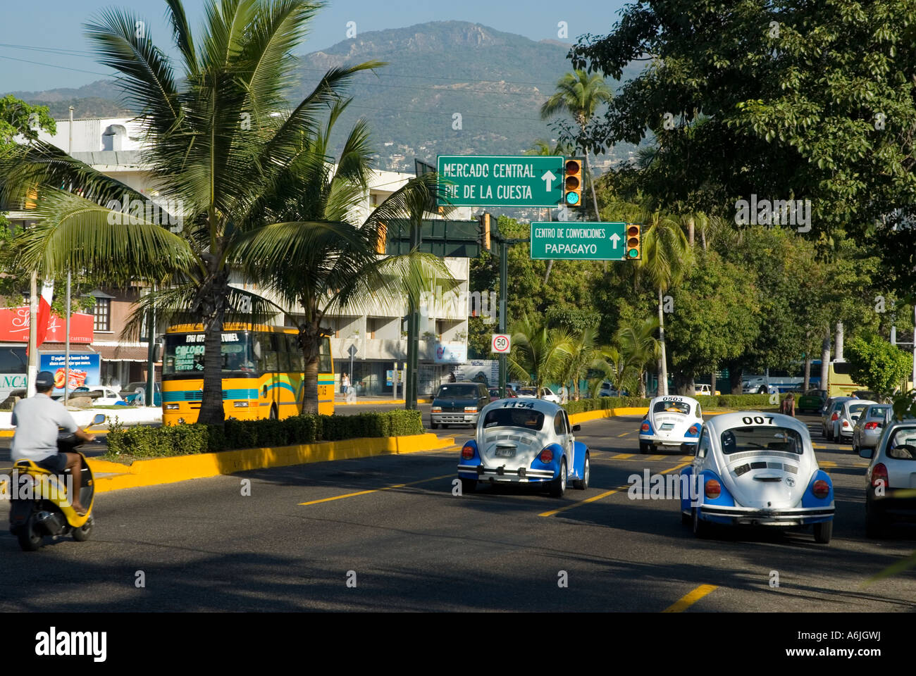 Acapulco street Costera with direction signs and cars that runs ...